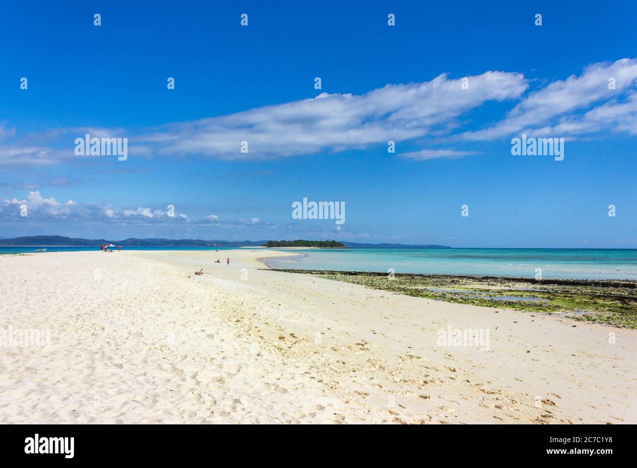 View of coastline of Iranja Island (Nosy Iranja) lined with palm trees ...