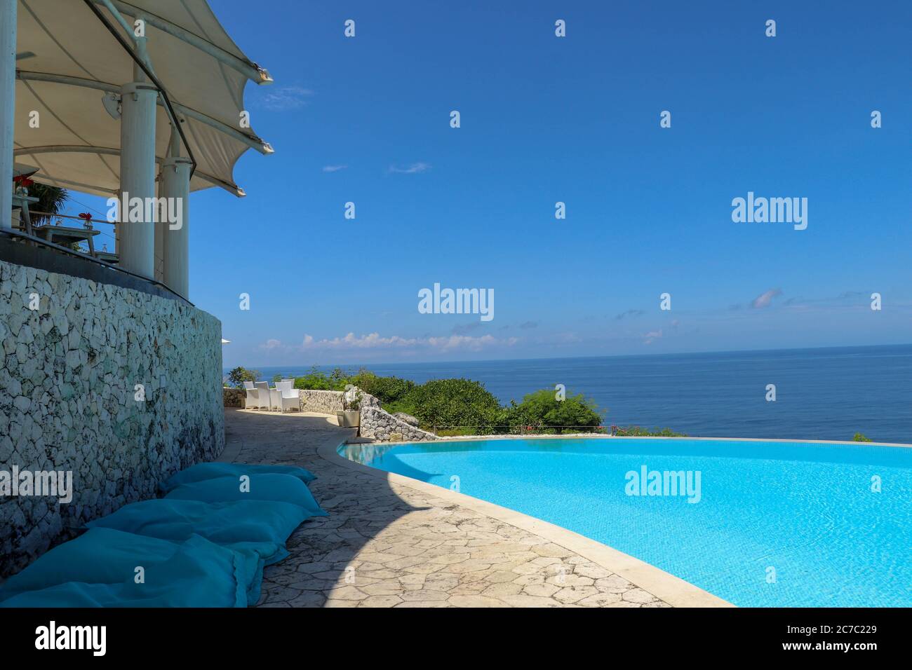 Luxury infinity pool with sea views and palm trees. Bali, Indonesia Stock Photo - Alamy