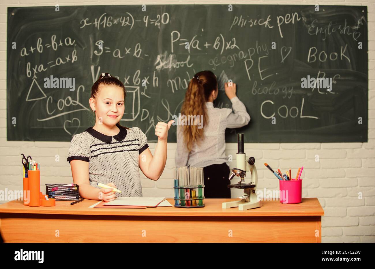 Science is my life. Little scientist work with microscope. Little girls ...