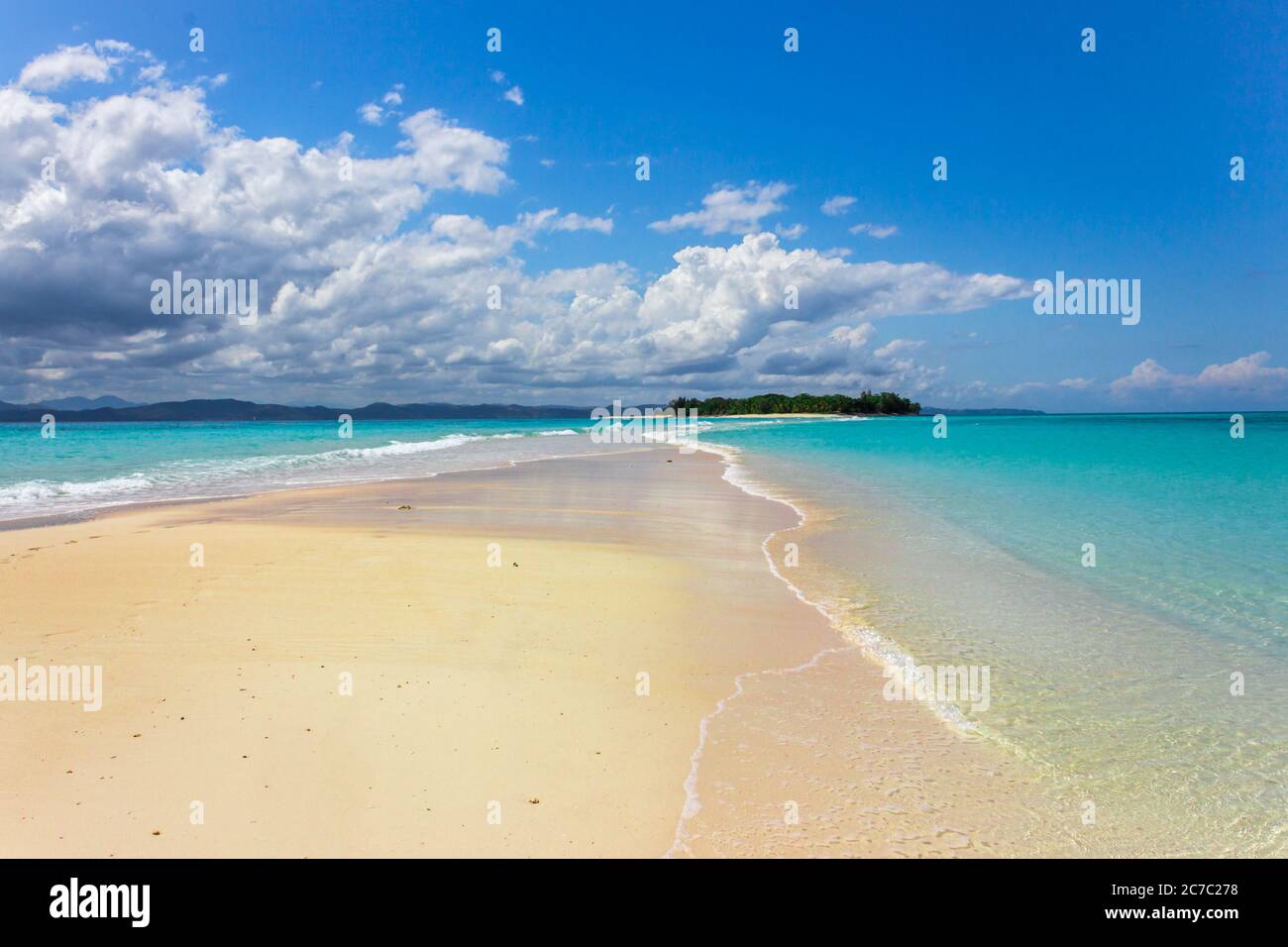 View of coastline of Iranja Island (Nosy Iranja) lined with palm trees ...
