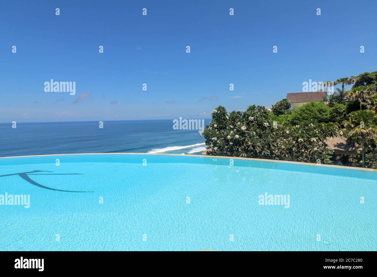 Luxury infinity pool with sea views and palm trees. Bali, Indonesia ...