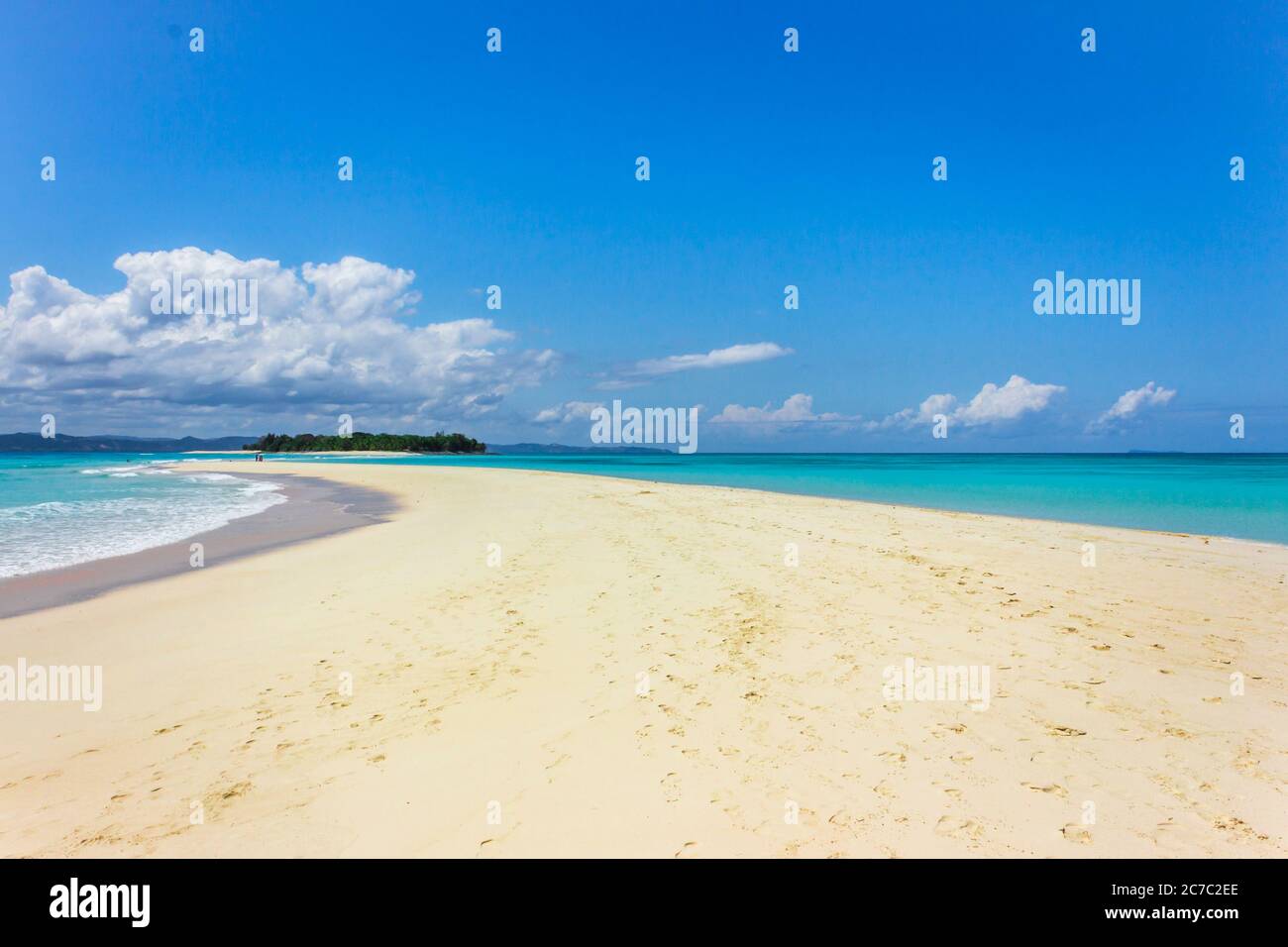 View of coastline of Iranja Island (Nosy Iranja) lined with palm trees ...
