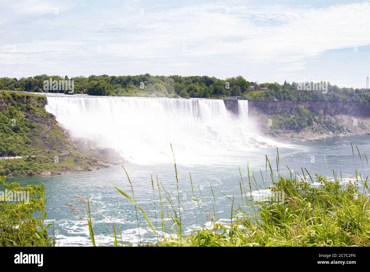 Landscape shot of a river with waterfalls flowing into the river and a ...
