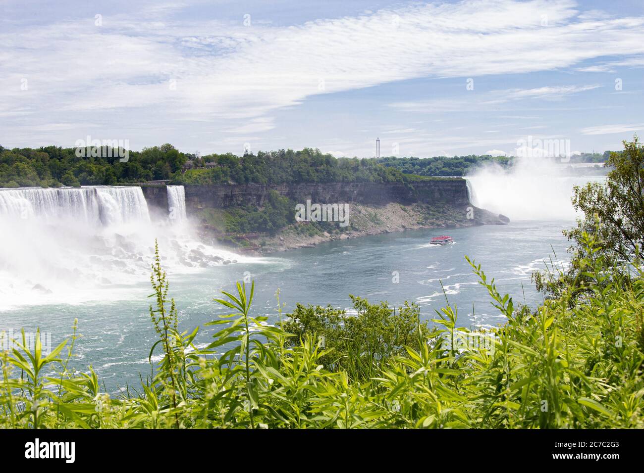 Landscape shot of a river with waterfalls flowing into the river and a ...
