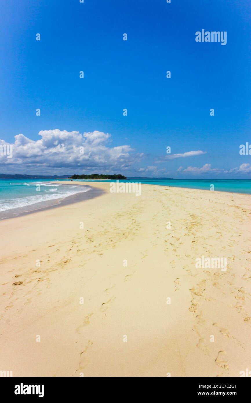 View of coastline of Iranja Island (Nosy Iranja) lined with palm trees ...