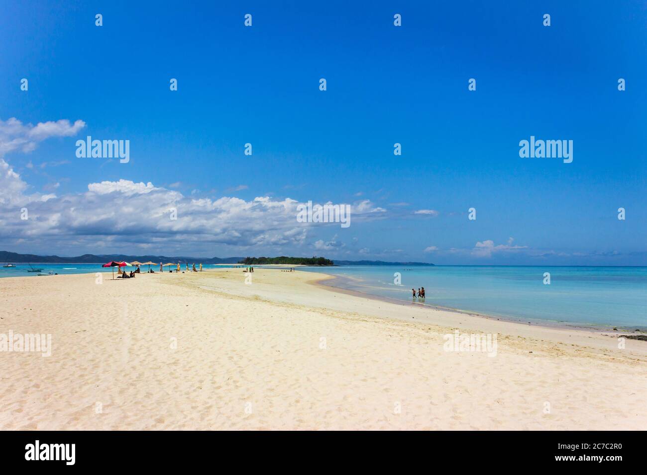 View of coastline of Iranja Island (Nosy Iranja) lined with palm trees ...