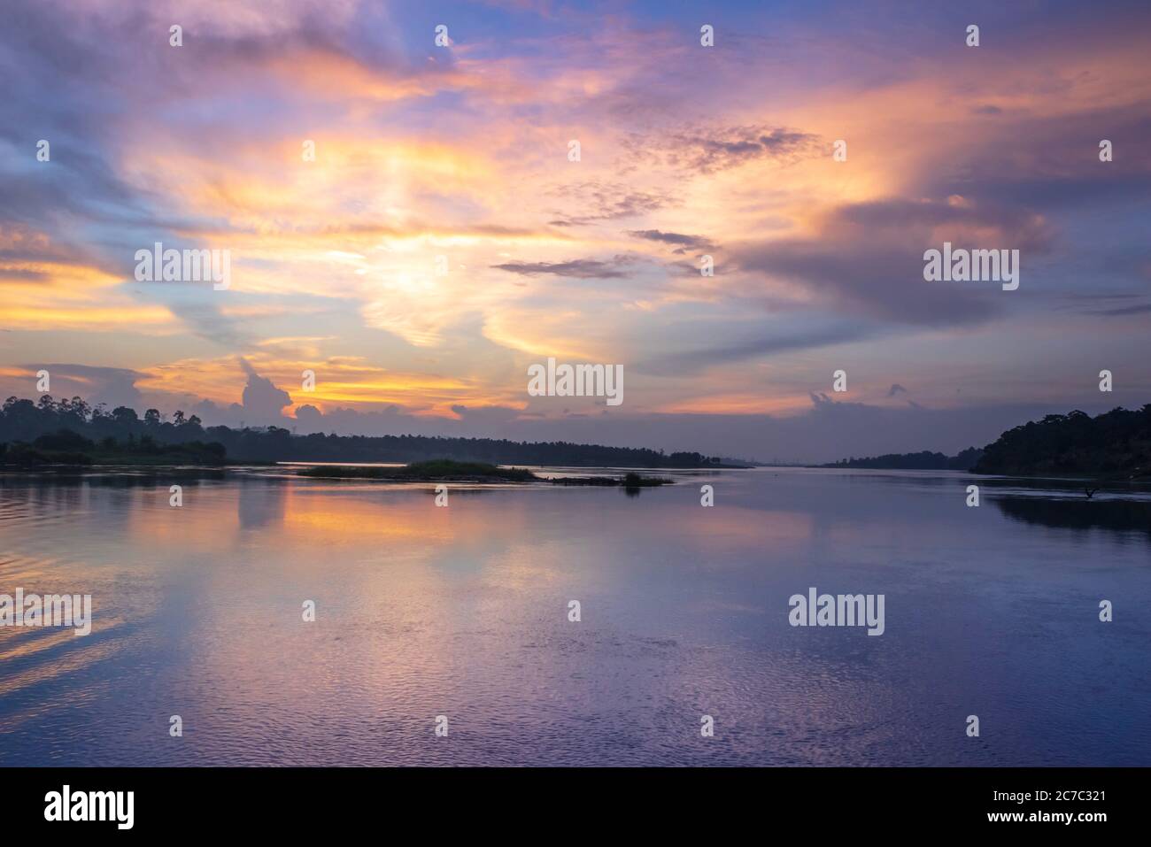Sunset view of the Victoria Nile river, with trees growing and the ...