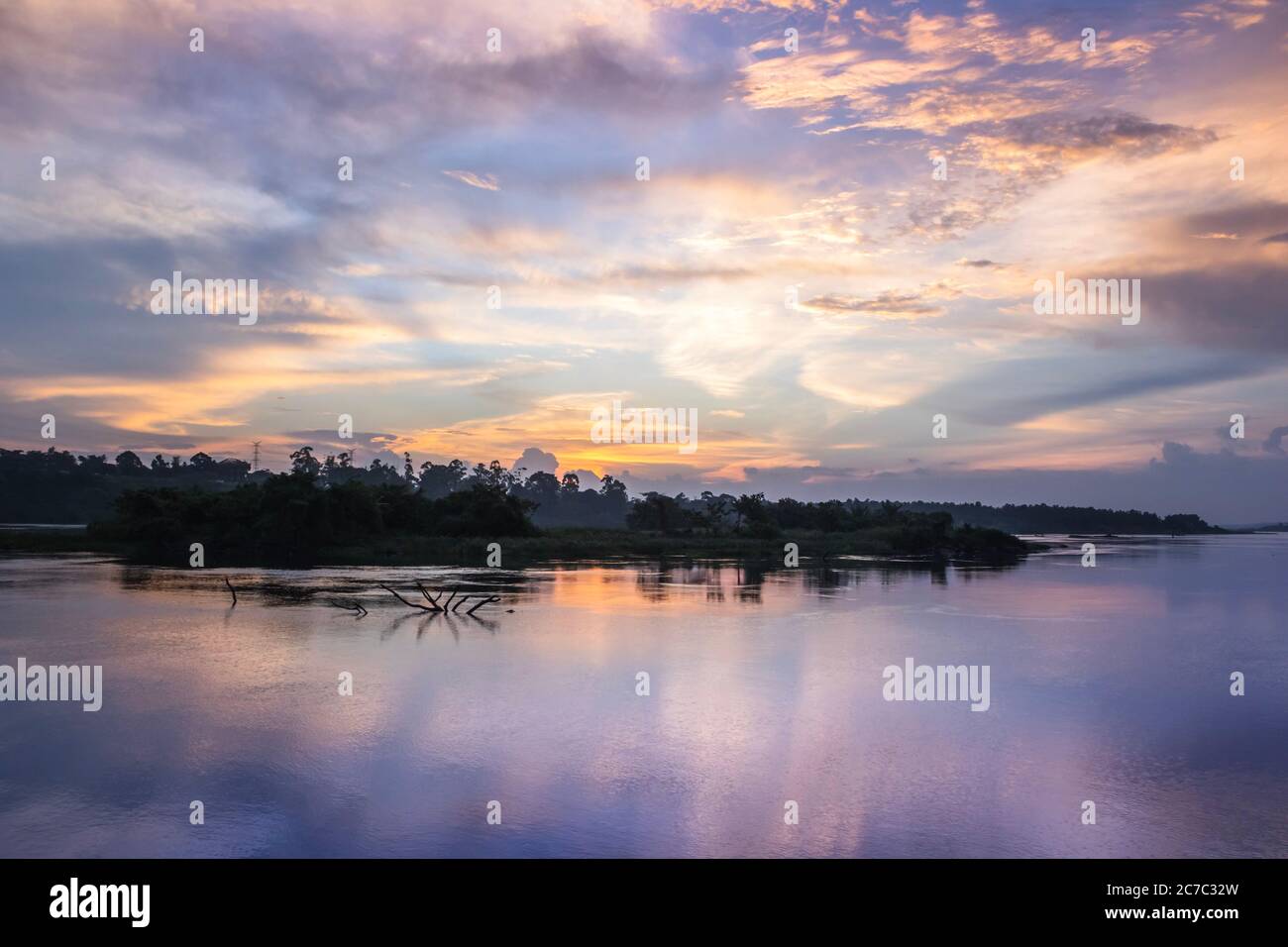 Sunset view of the Victoria Nile river, with trees growing and the ...