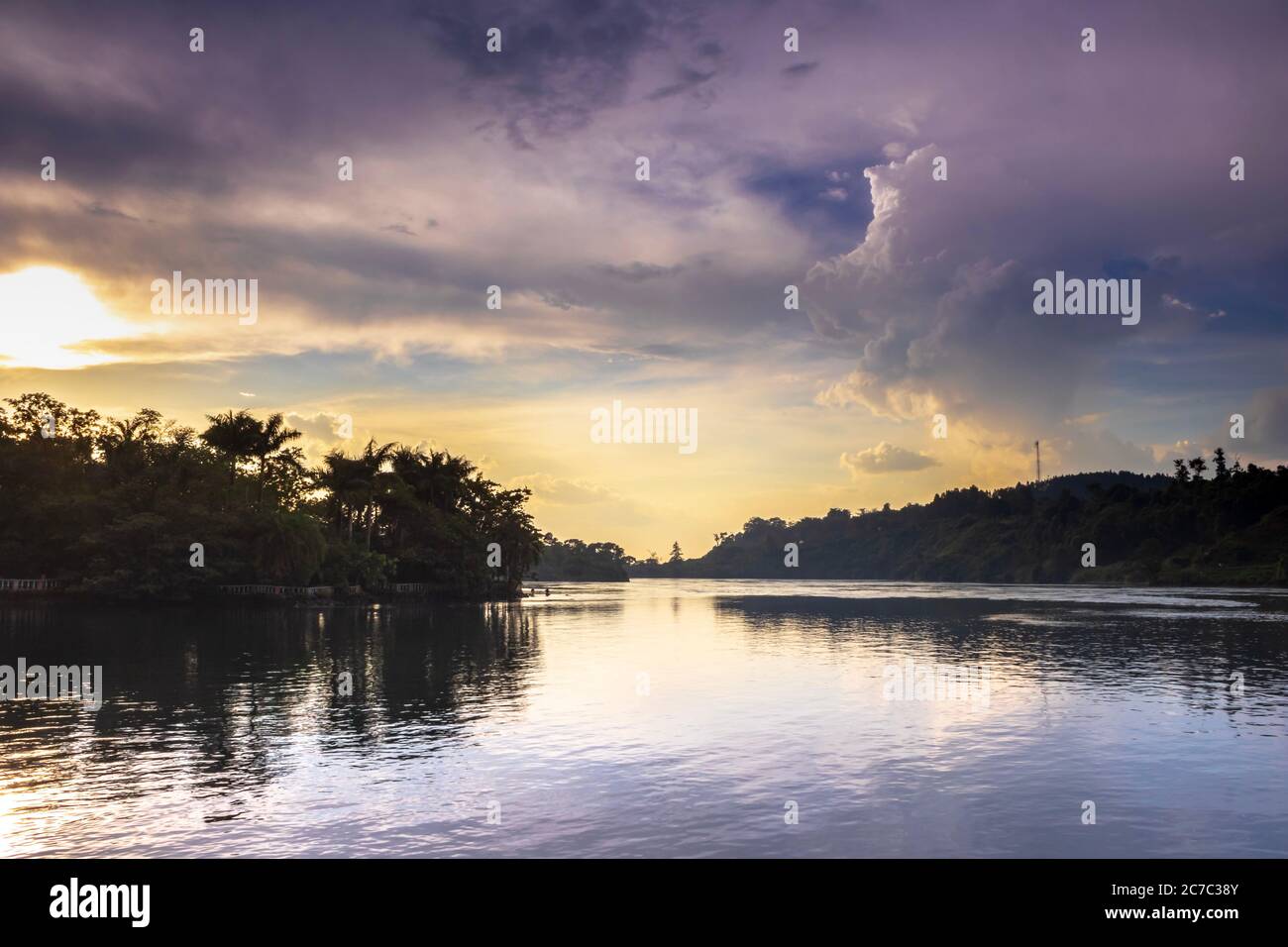 Sunset view of the Victoria Nile river, with trees growing and the ...