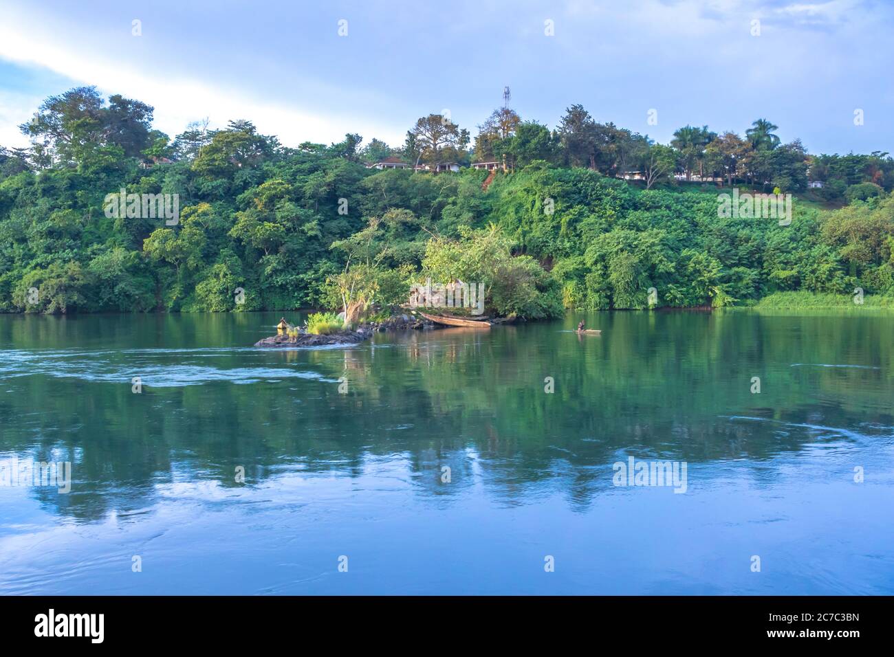 Sunset view of the Victoria Nile river, with trees growing and the ...