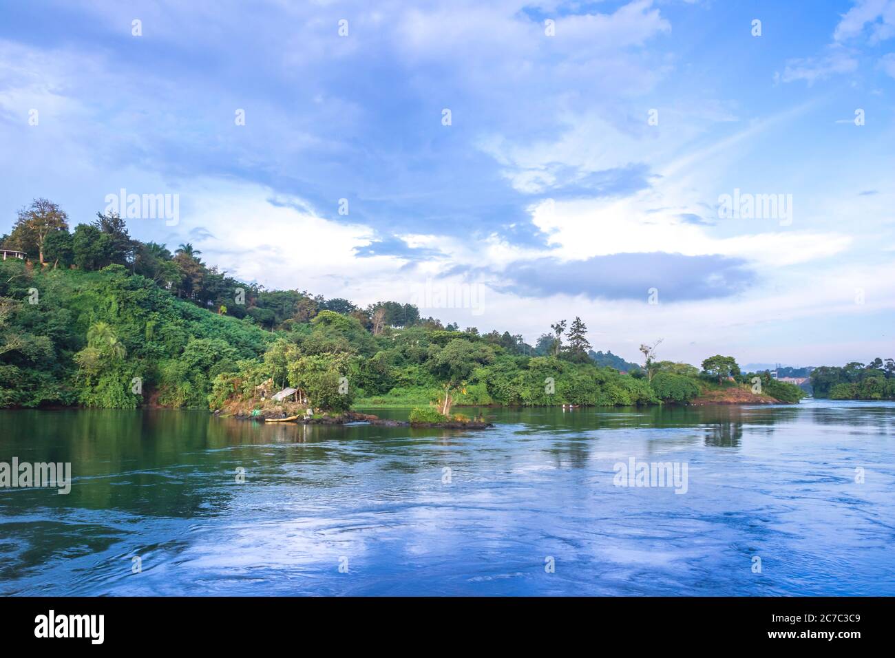 Sunset view of the Victoria Nile river, with trees growing and the ...