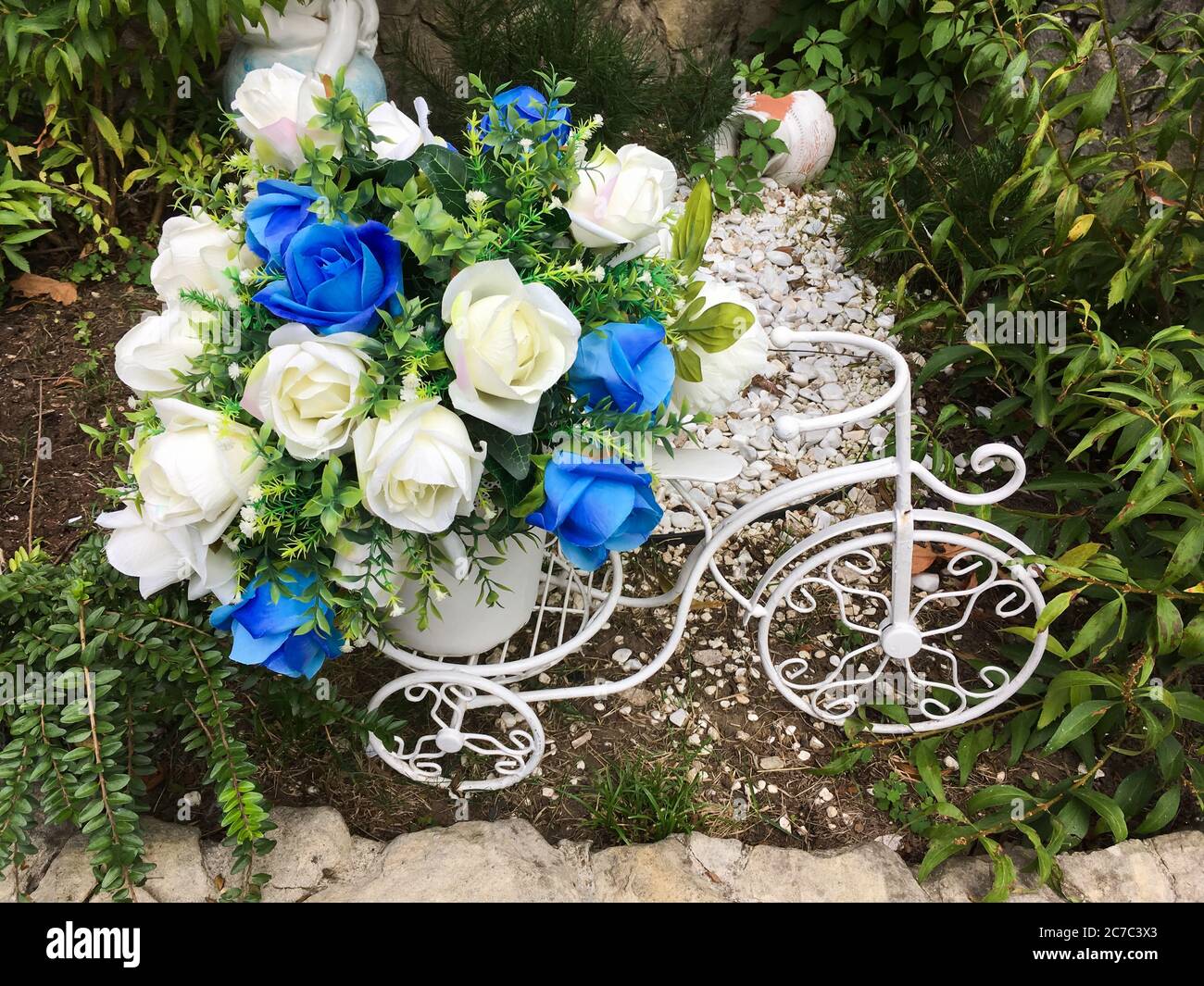 Closeup shot white metallic tricycle with flowers in it as a wedding ...