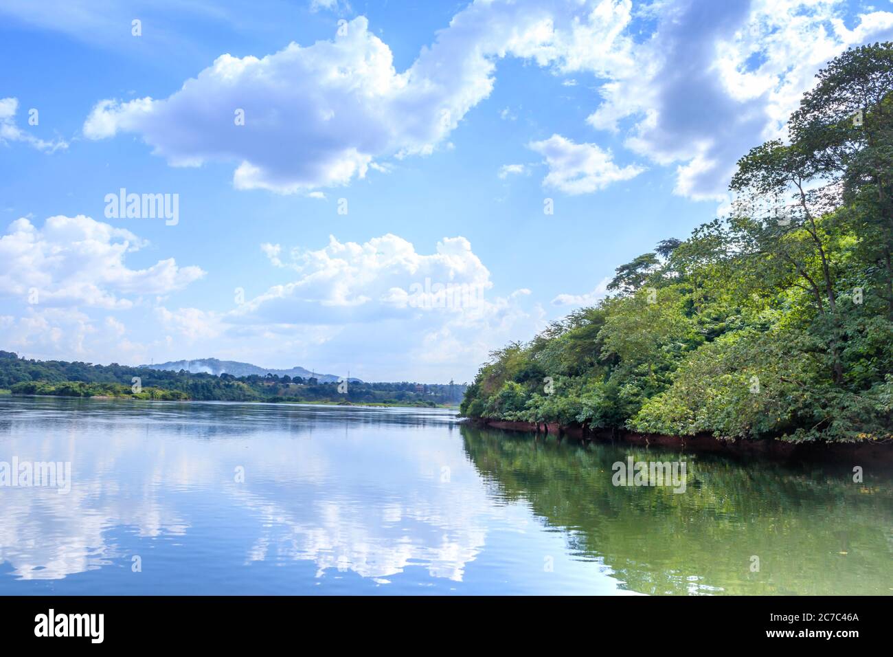 Sunset view of the Victoria Nile river, with trees growing and the ...
