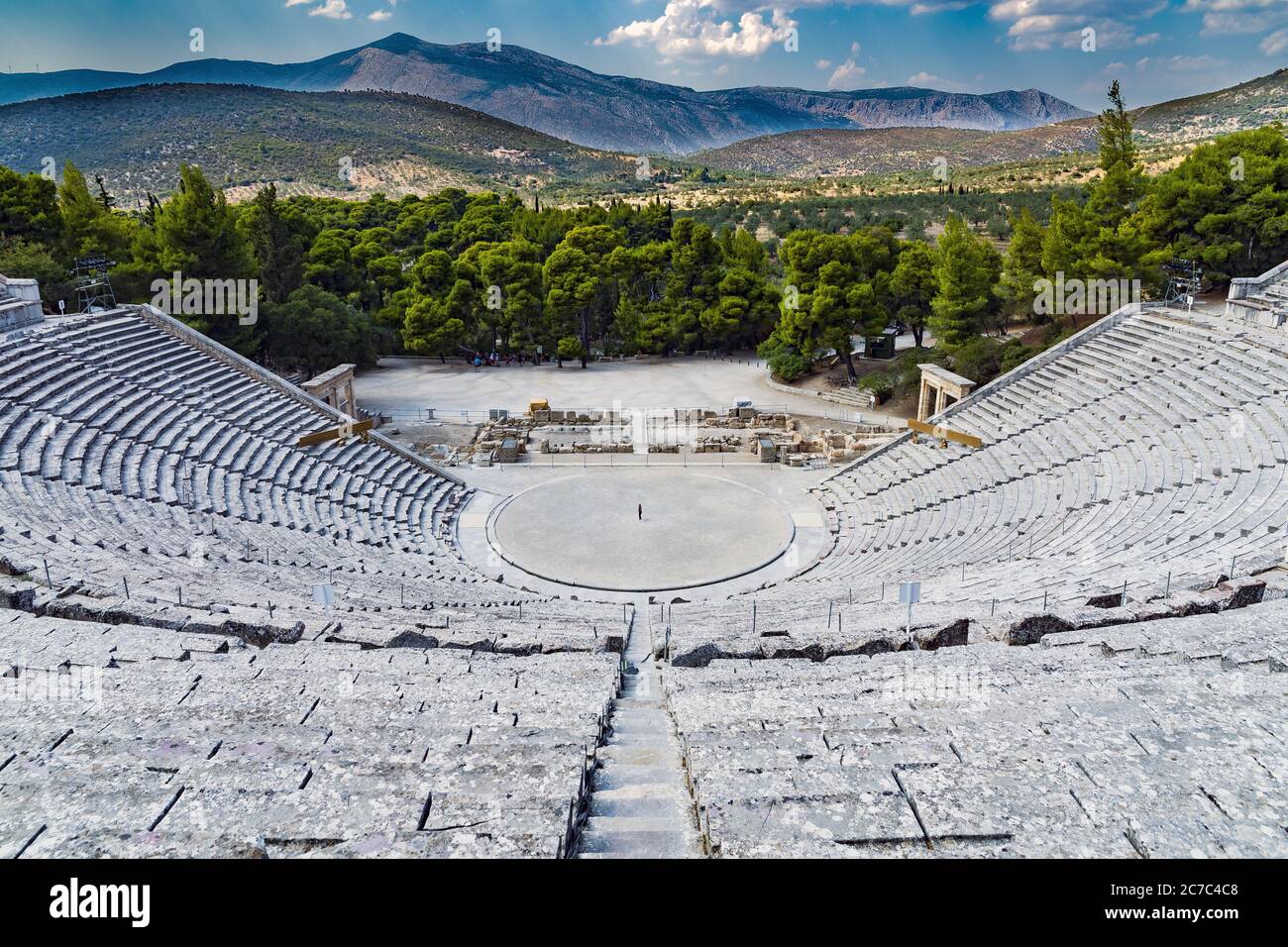 High shot of an amphitheater made out of stone with green trees and ...
