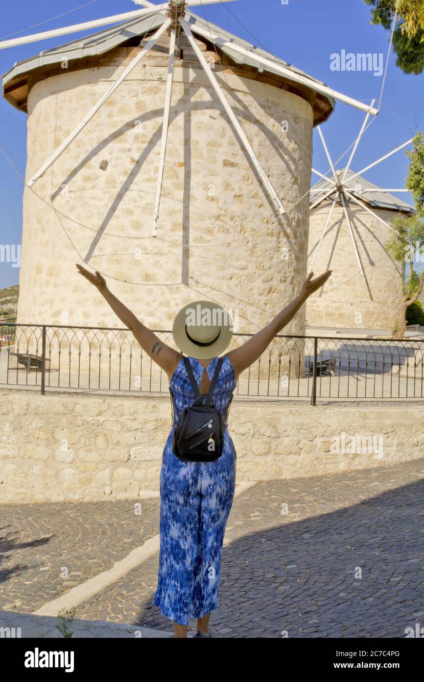 young woman standing front of the windmill Stock Photo - Alamy