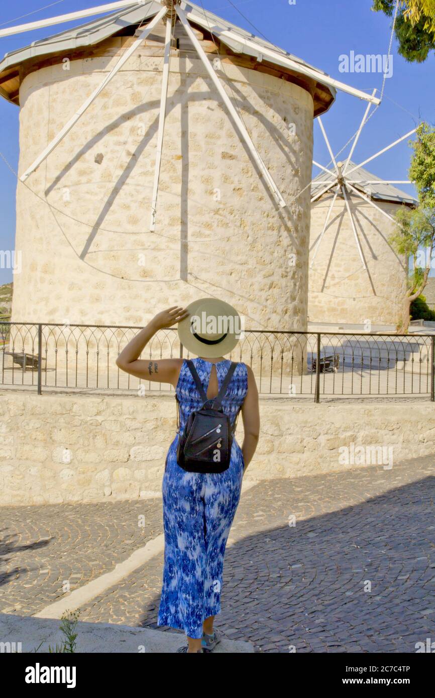 young woman standing front of the windmill Stock Photo - Alamy
