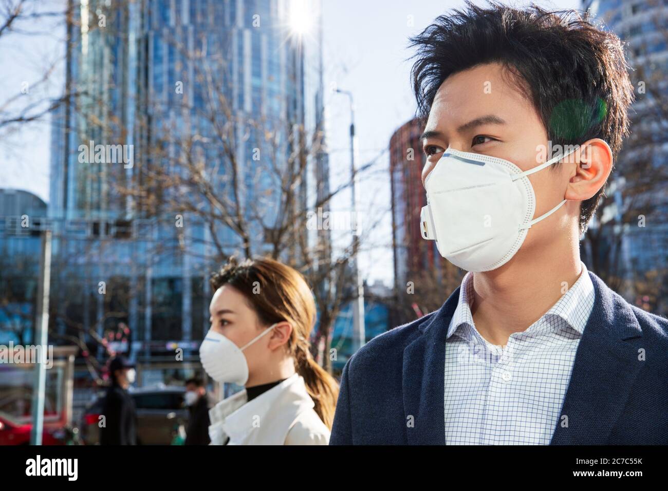 Wearing a mask of business people Stock Photo - Alamy