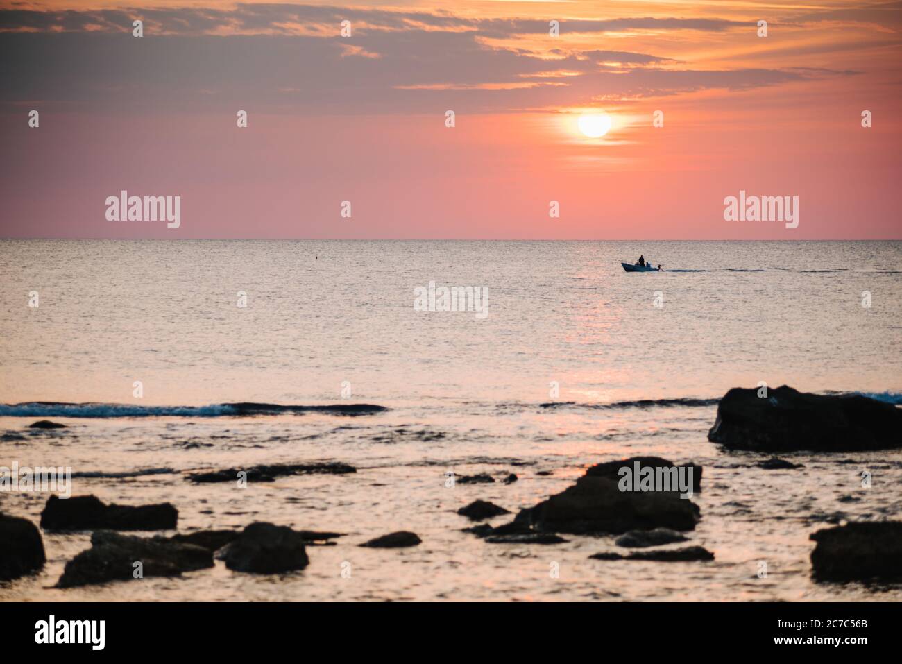 Horizontal shot of a body of water with rocks near the shore during ...