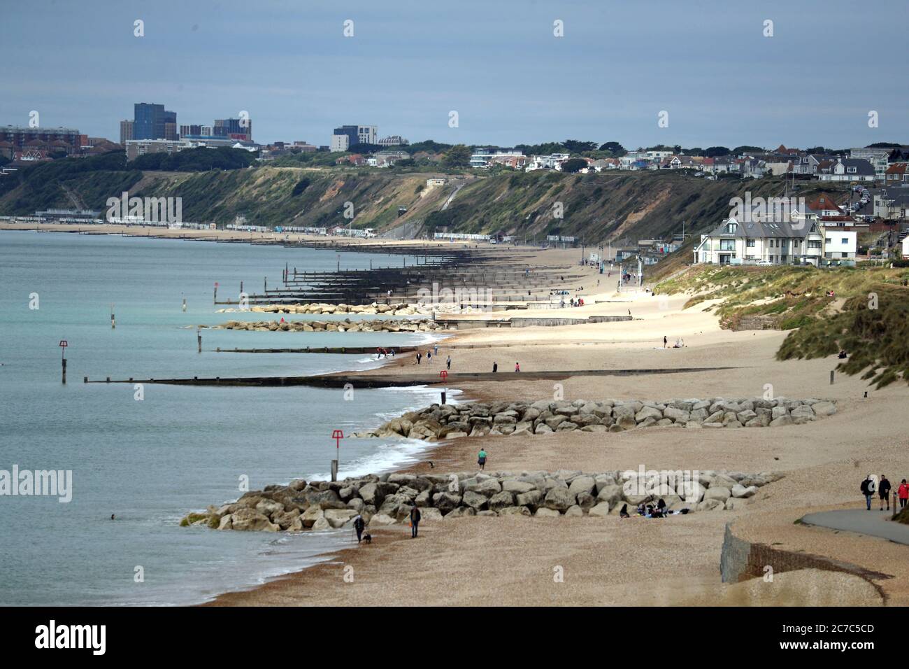 People walking along Southbourne Beach near Bournemoth in Dorset Stock ...