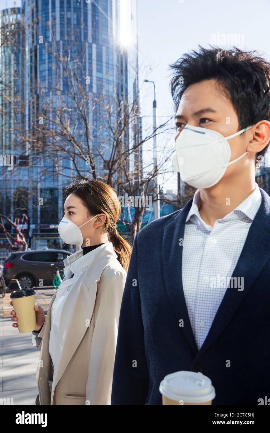 Wearing a mask of business people Stock Photo - Alamy