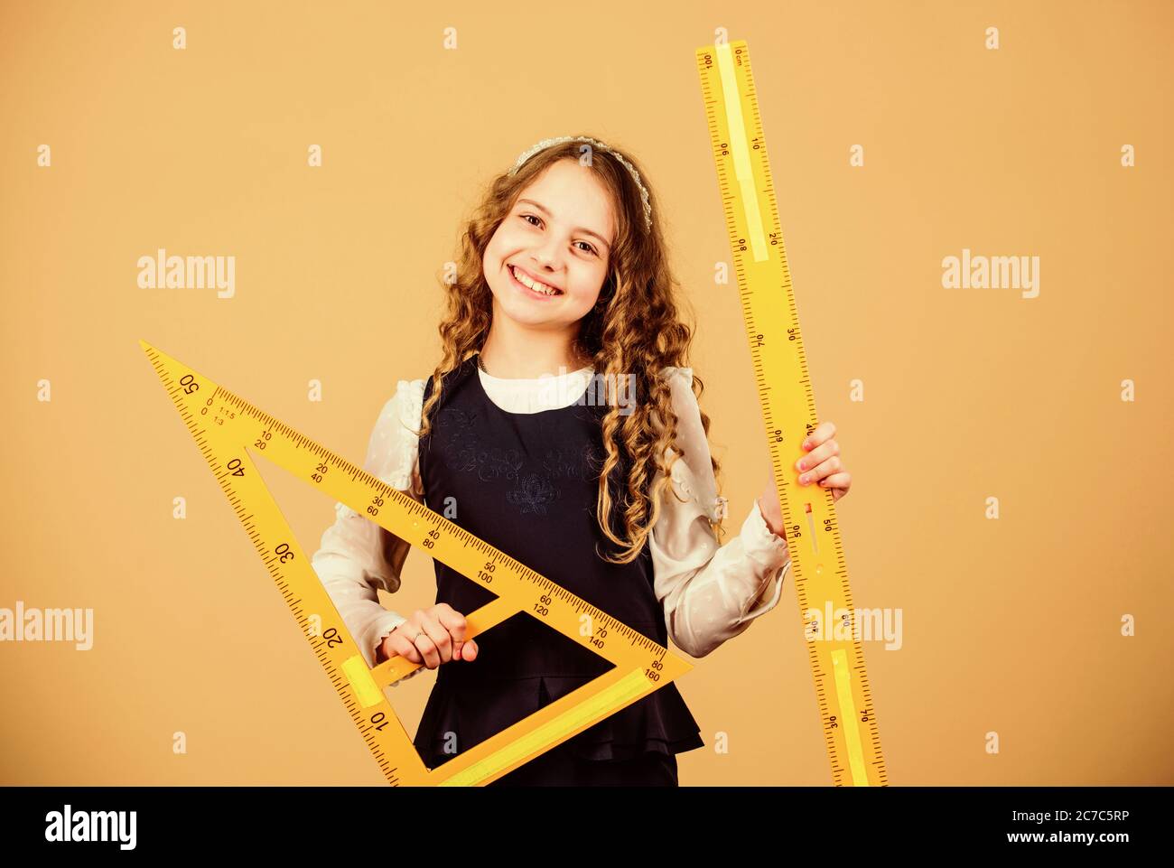 small girl back to school. Pupil girl with big rulers. STEM school ...