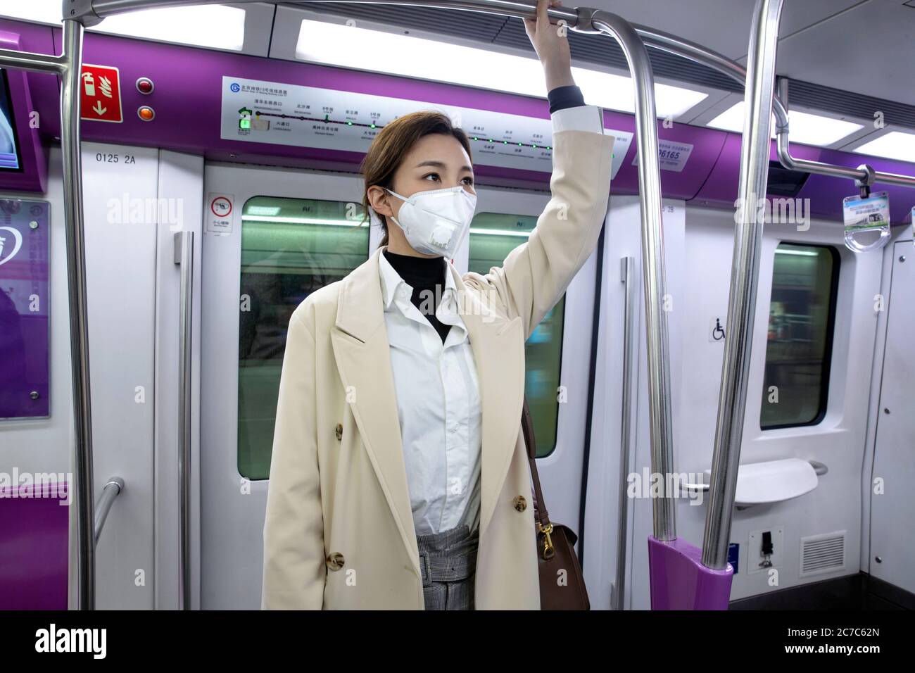 Young women take the subway Stock Photo - Alamy