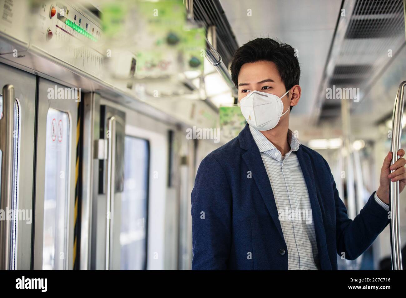 Wearing a mask of the young man take the subway Stock Photo - Alamy