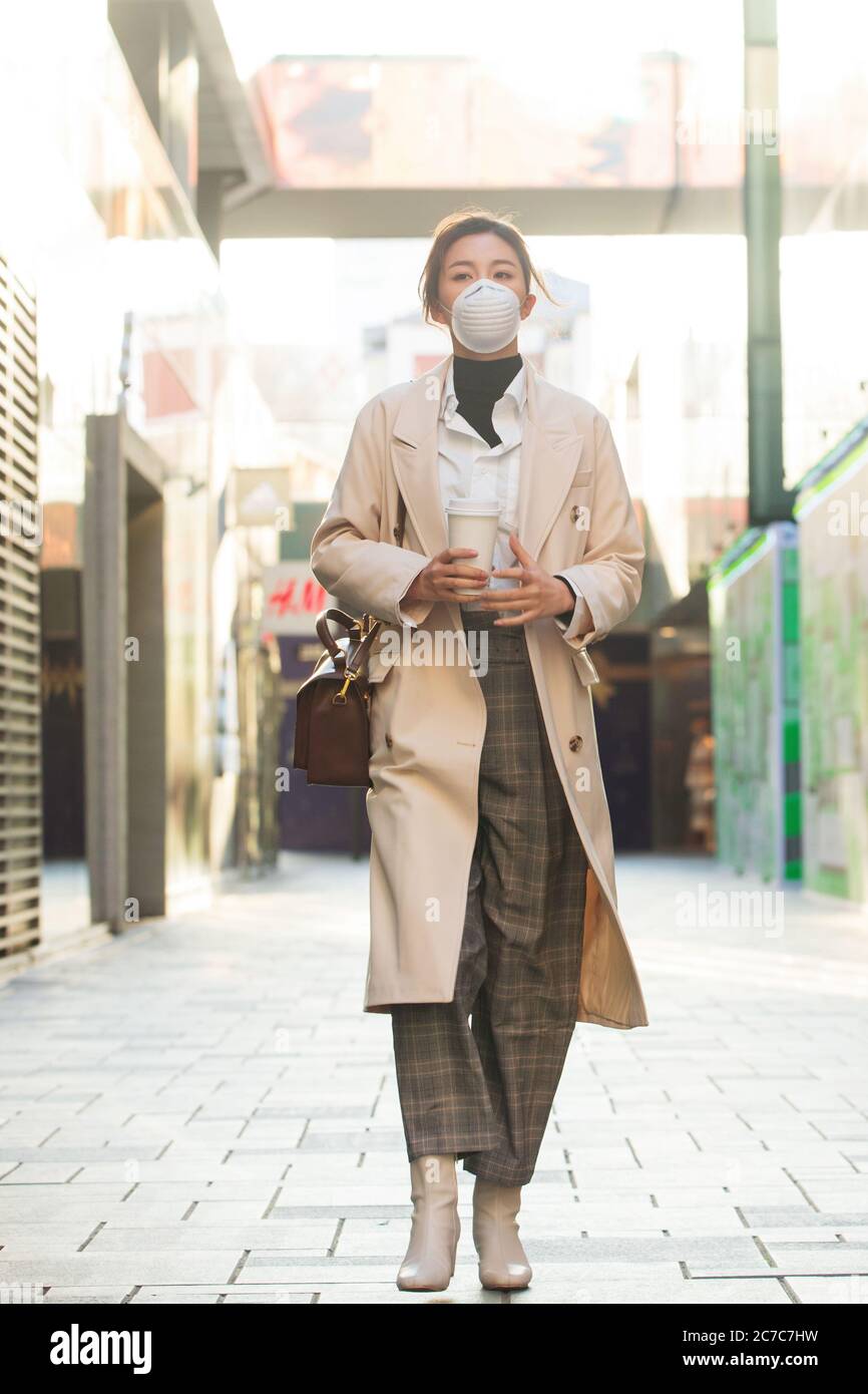 Outdoor wearing a mask of the young woman Stock Photo - Alamy
