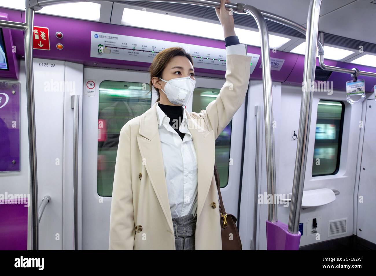 Young women take the subway Stock Photo - Alamy
