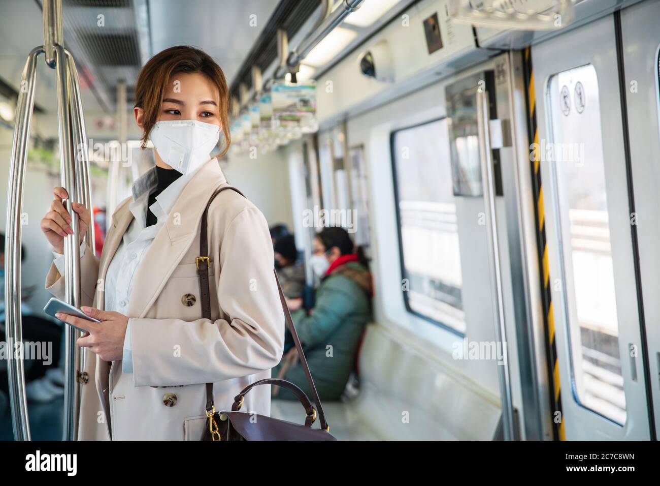 Wearing a mask of the young women take the subway Stock Photo - Alamy