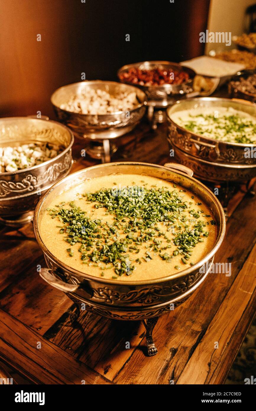 Vertical shot of pots full of food aligned on a wooden table Stock ...