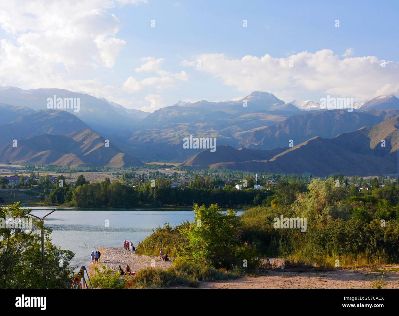 Calm scene at Lake Issyk Kul in Kyrgyzstan with mountains in the ...