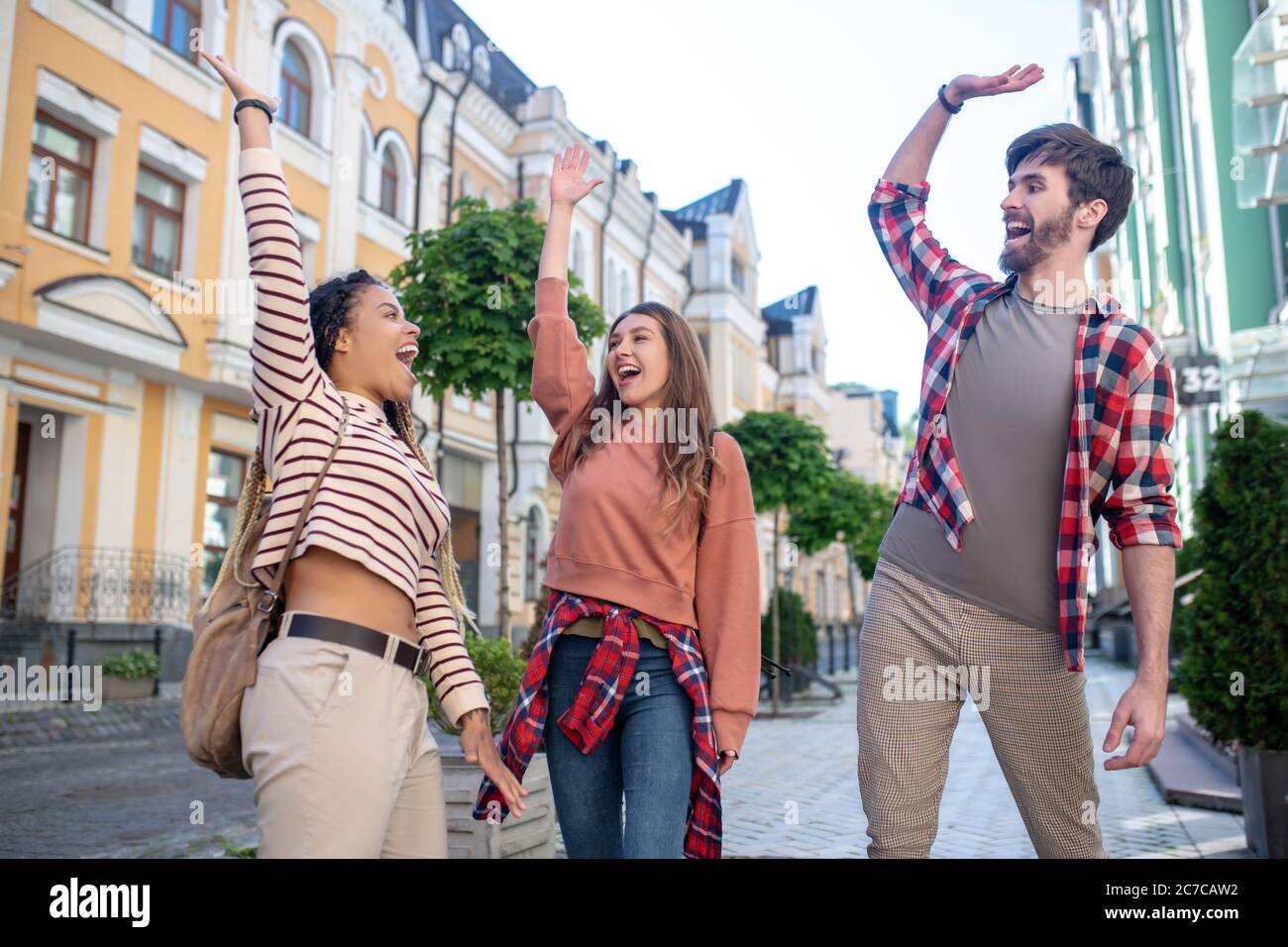 Three young friends having fun in the city Stock Photo - Alamy