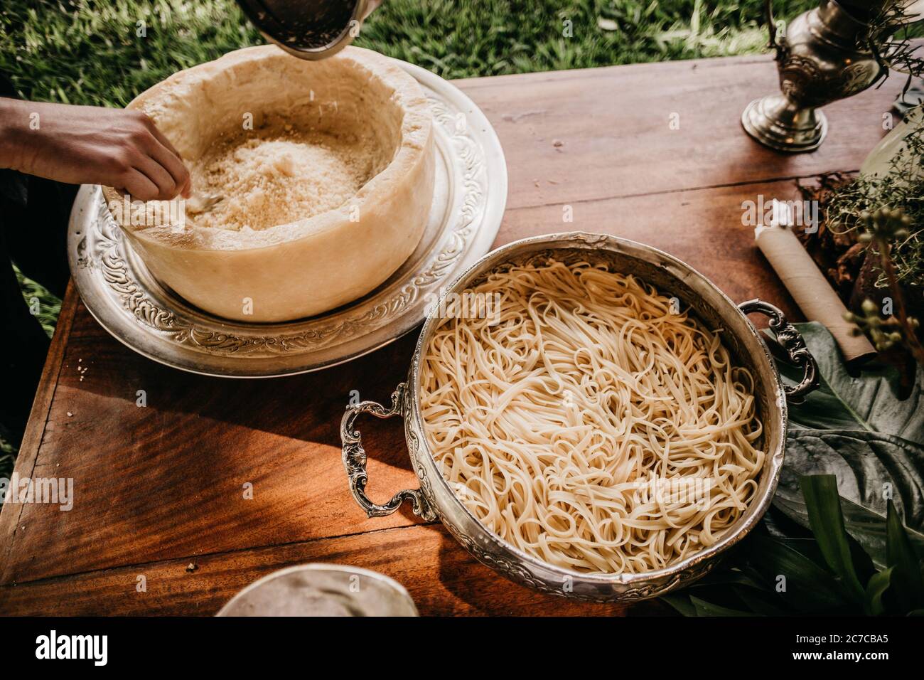 Overhead shot of a parmesan wheel in a plate and past in a pot Stock ...