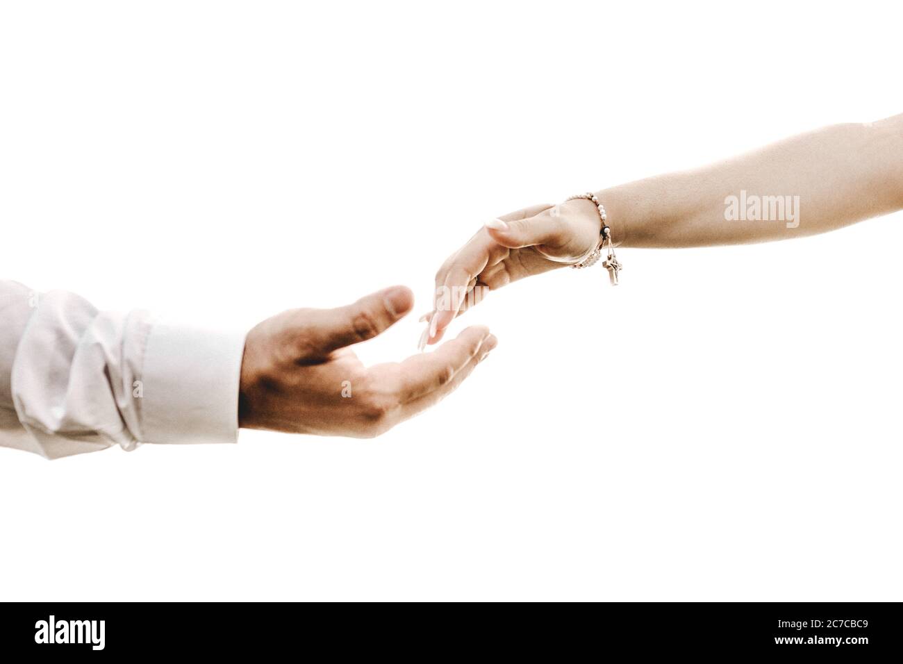 Horizontal shot of a man's hand reaching out to a woman's hand with a ...