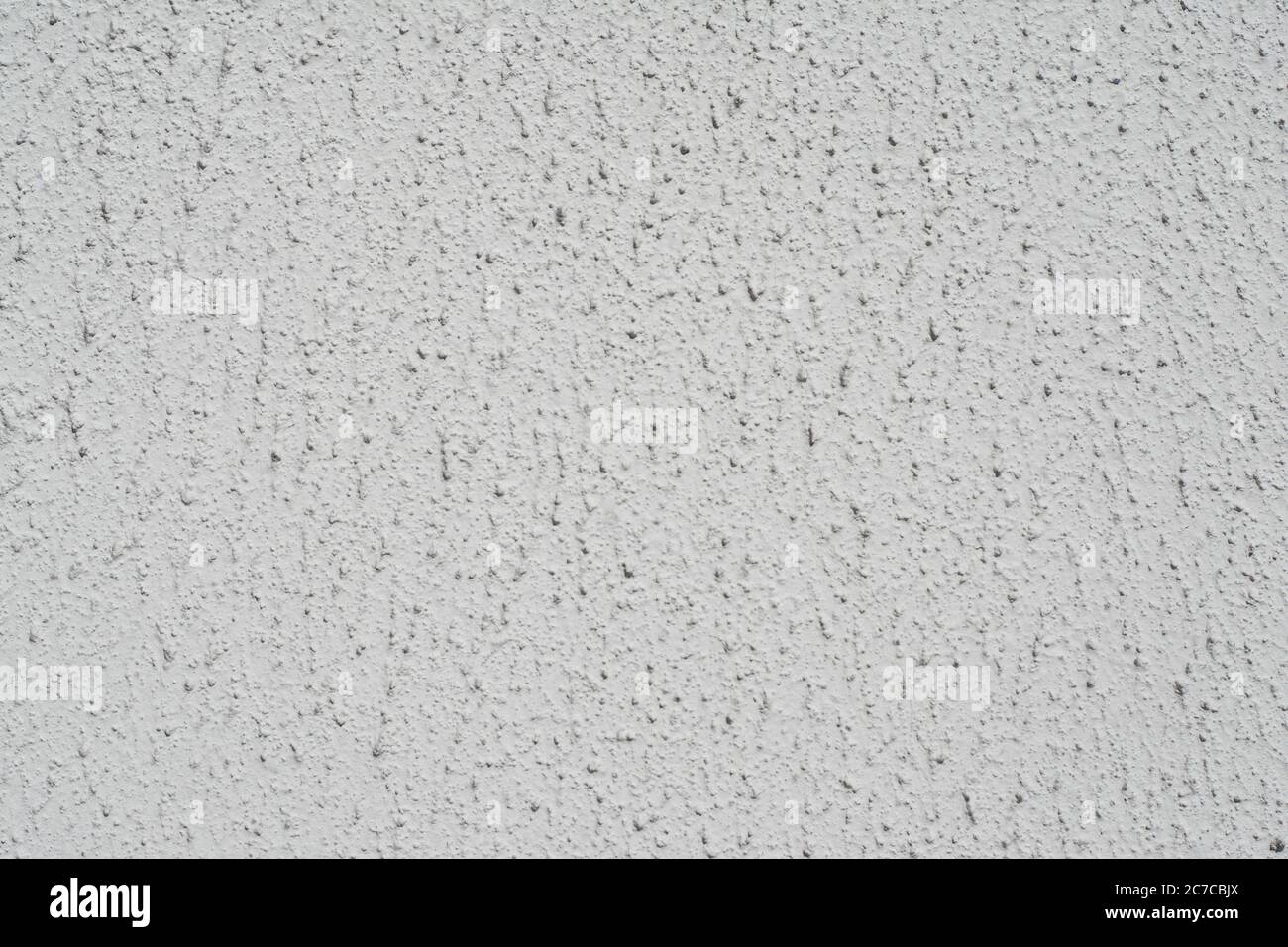 Part of the texture of a white wall decorated with decorative putty ...