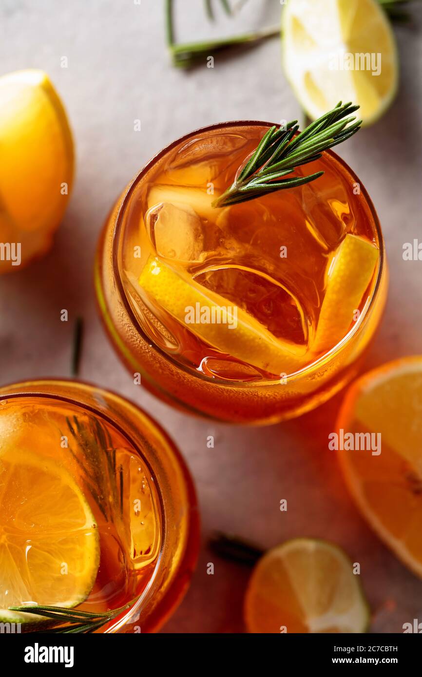 Traditional iced tea with lemon, lime and ice garnished with rosemary ...