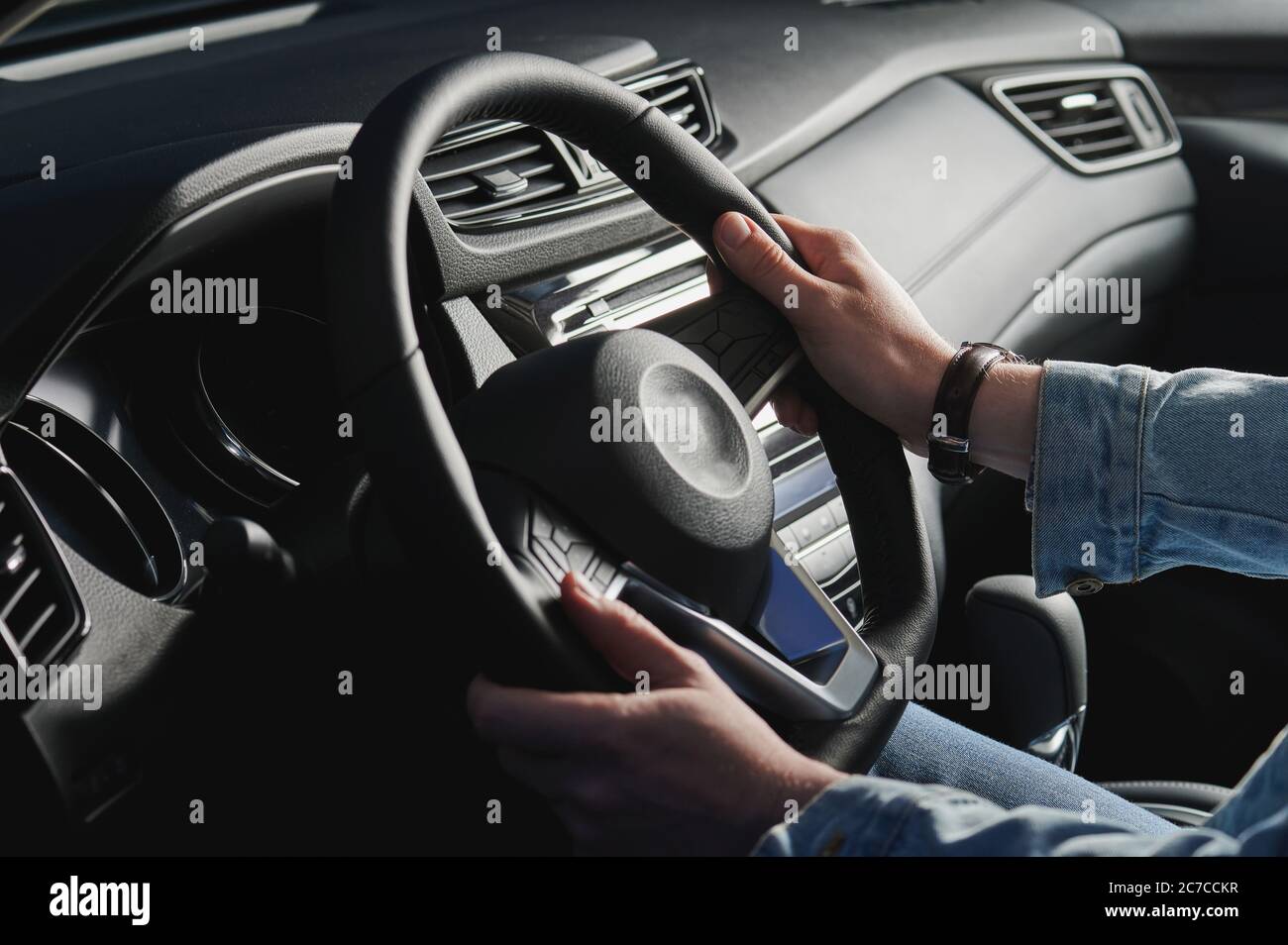 Man hold hands on car steering wheel close up view Stock Photo - Alamy
