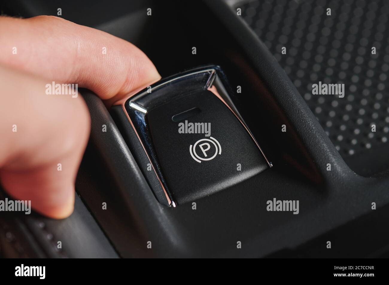 Activate electronic car hand break button close up view Stock Photo - Alamy
