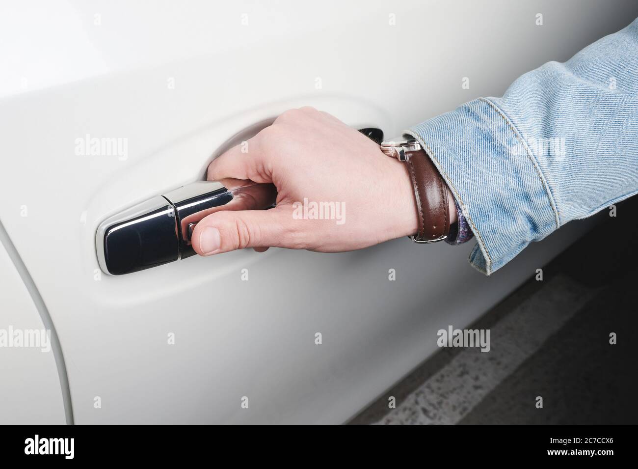 Hand hold handle of white car with touch lock close up view Stock Photo ...