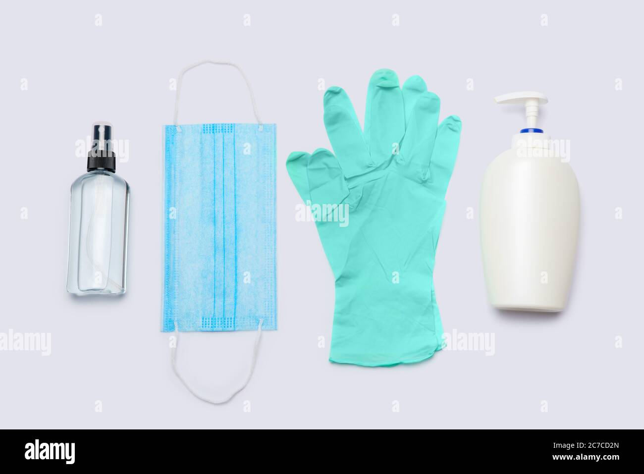 flat layout of hygiene items - latex gloves, mask and hand sanitizer ...