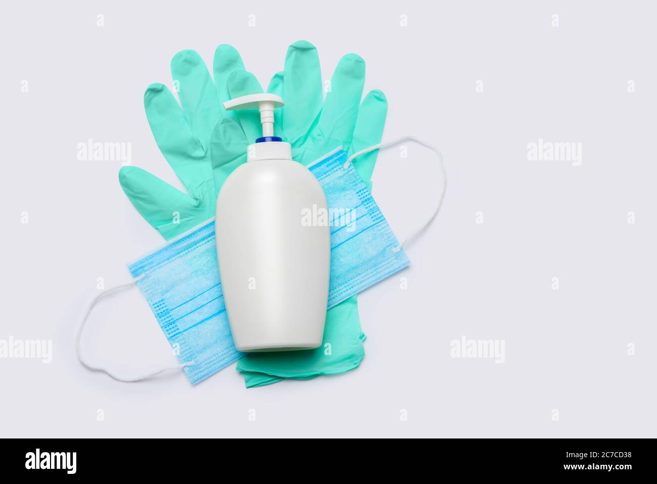 flat layout of hygiene items - latex gloves, mask and hand sanitizer ...