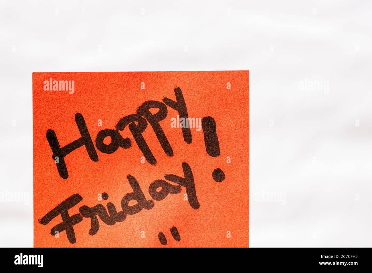Happy Friday handwriting text close up isolated on orange paper with ...