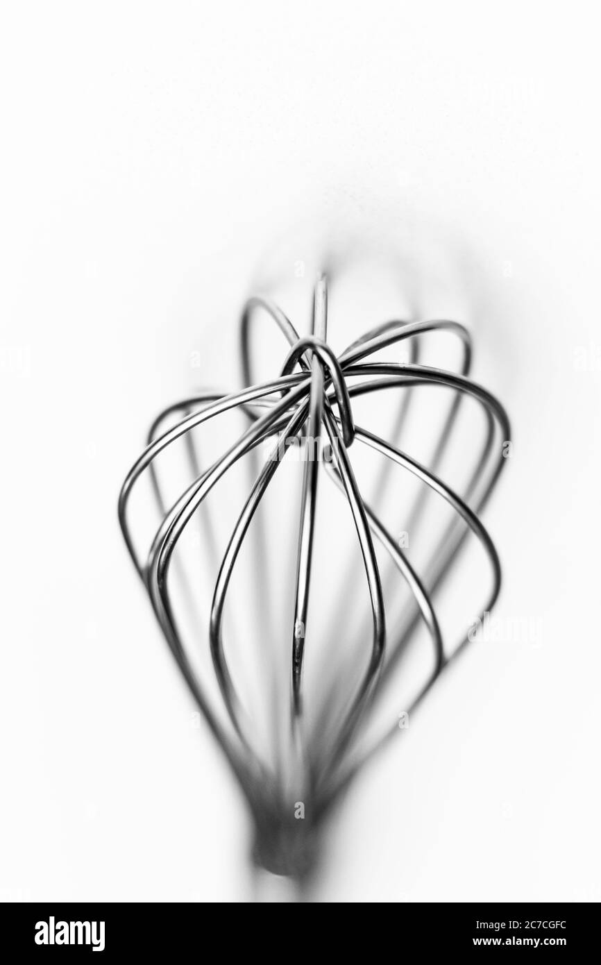 Selective closeup greyscale shot of whisks on a white background Stock ...