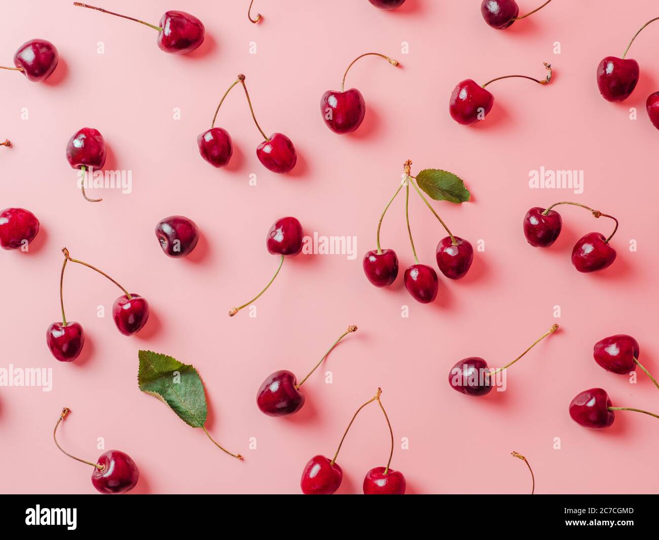 Fresh cherries scattered on pink background. Creative fresh cherry ...