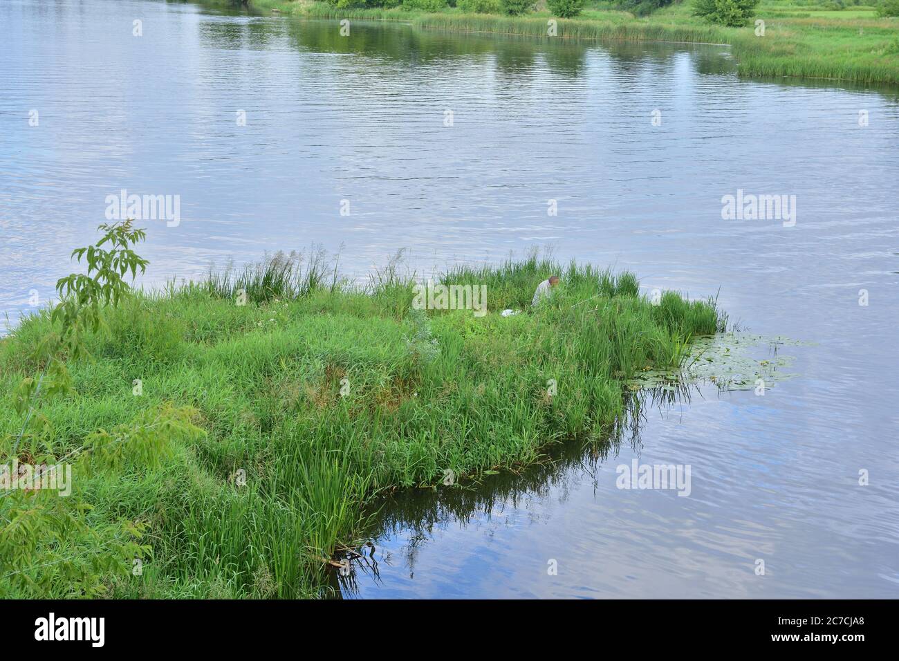 Angler and fisherman fish on the shore, next to the boat. Summer Stock ...