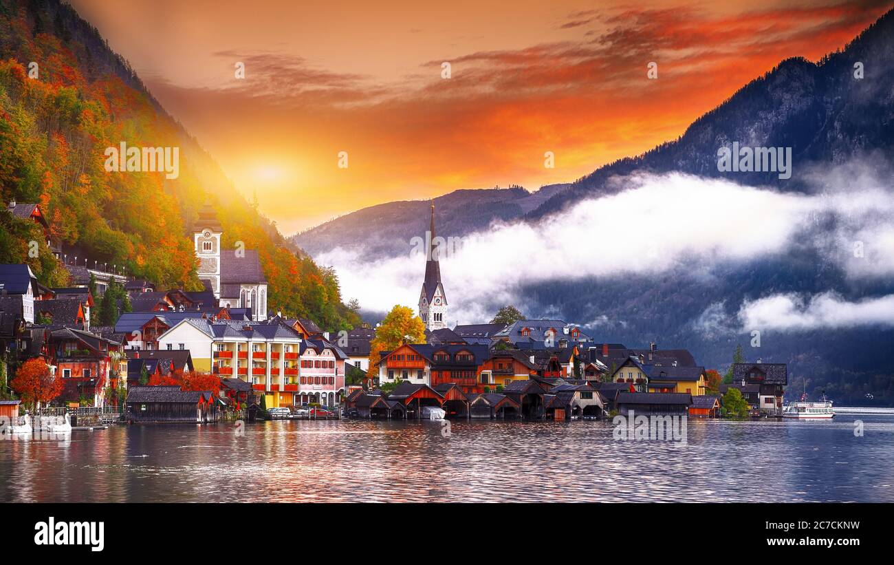 Scenic view of famous Hallstatt mountain village with Hallstatter lake. Foggy autumn sunrise on ...