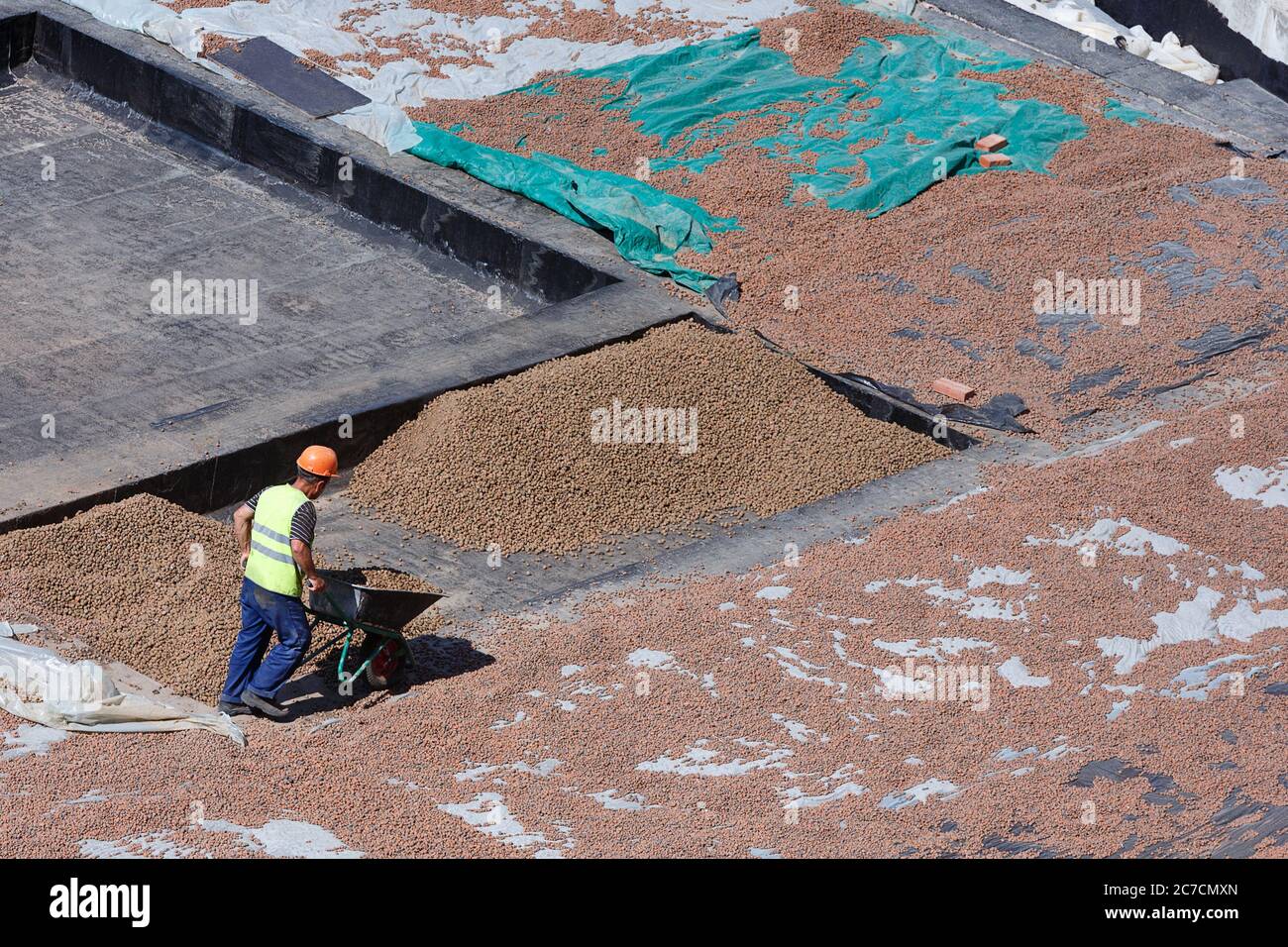 The process of thermal insulation of the roof by workers, by filling ...