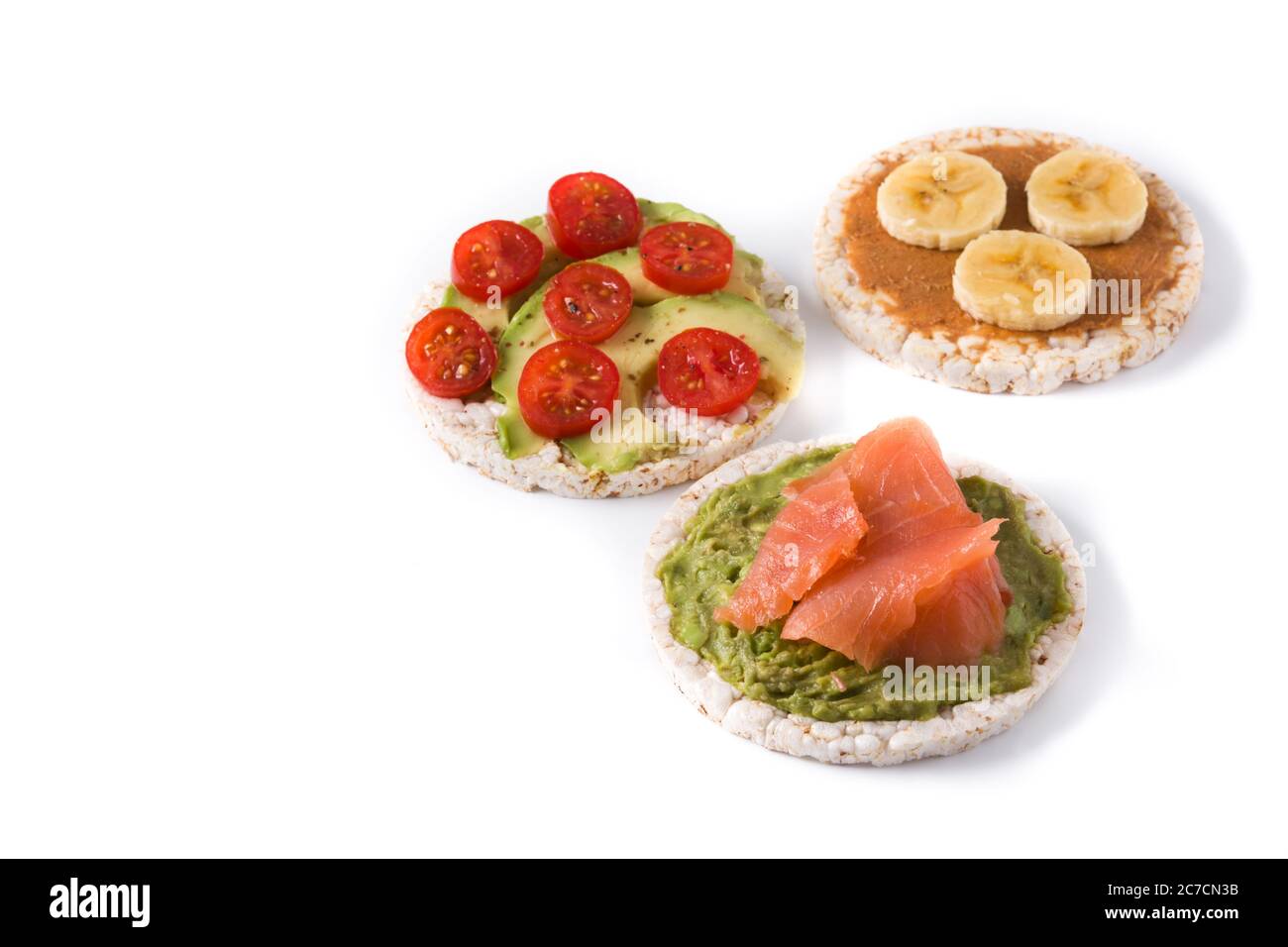 Assortment of ingredients on puffed rice cakes isolated on white ...