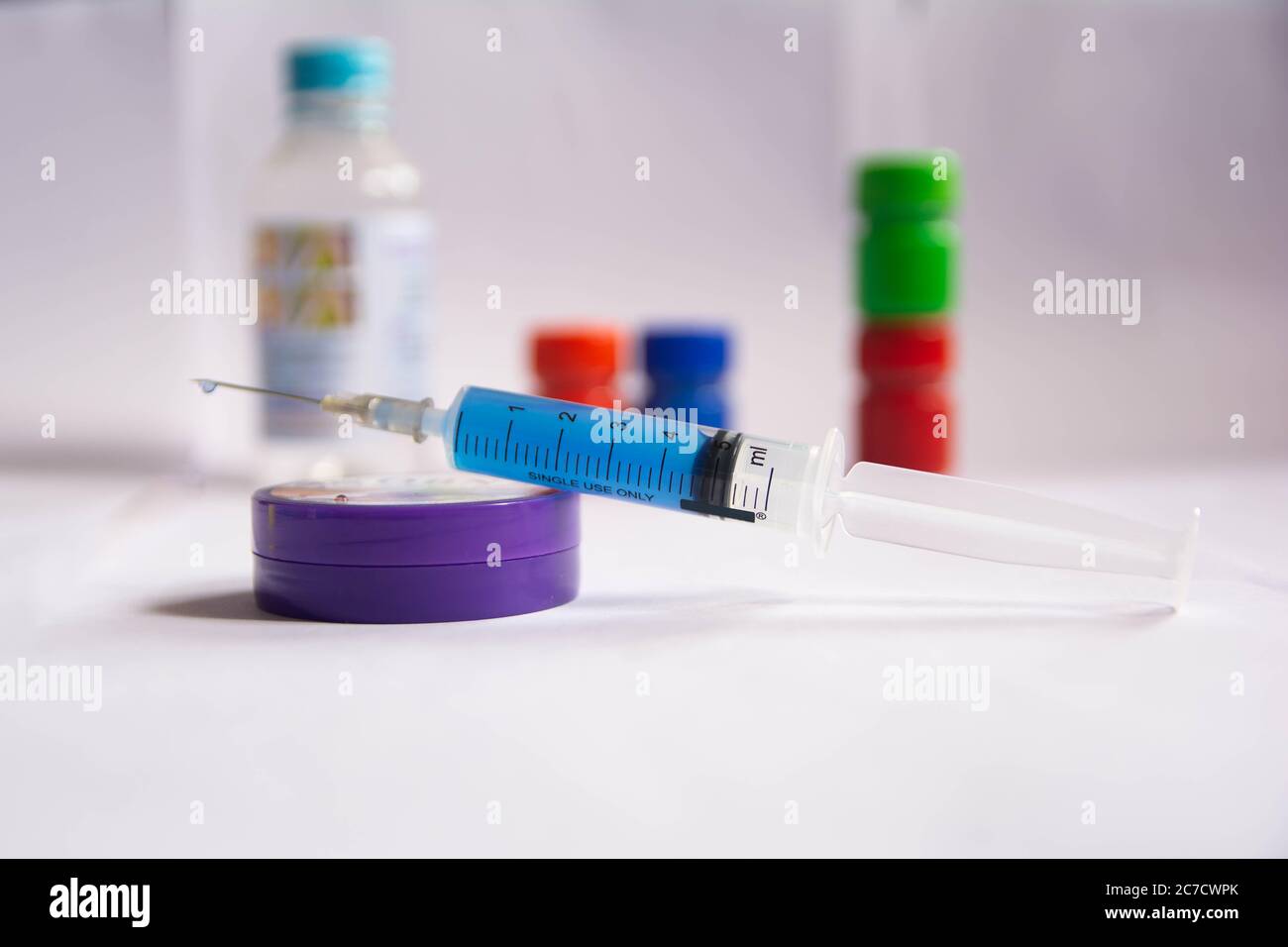 Medical syringe with blue liquid isolated on white background Stock ...